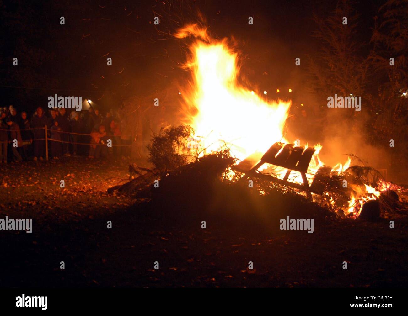 Crowds watch a burning bonfire at a fireworks display and bonfire at ...