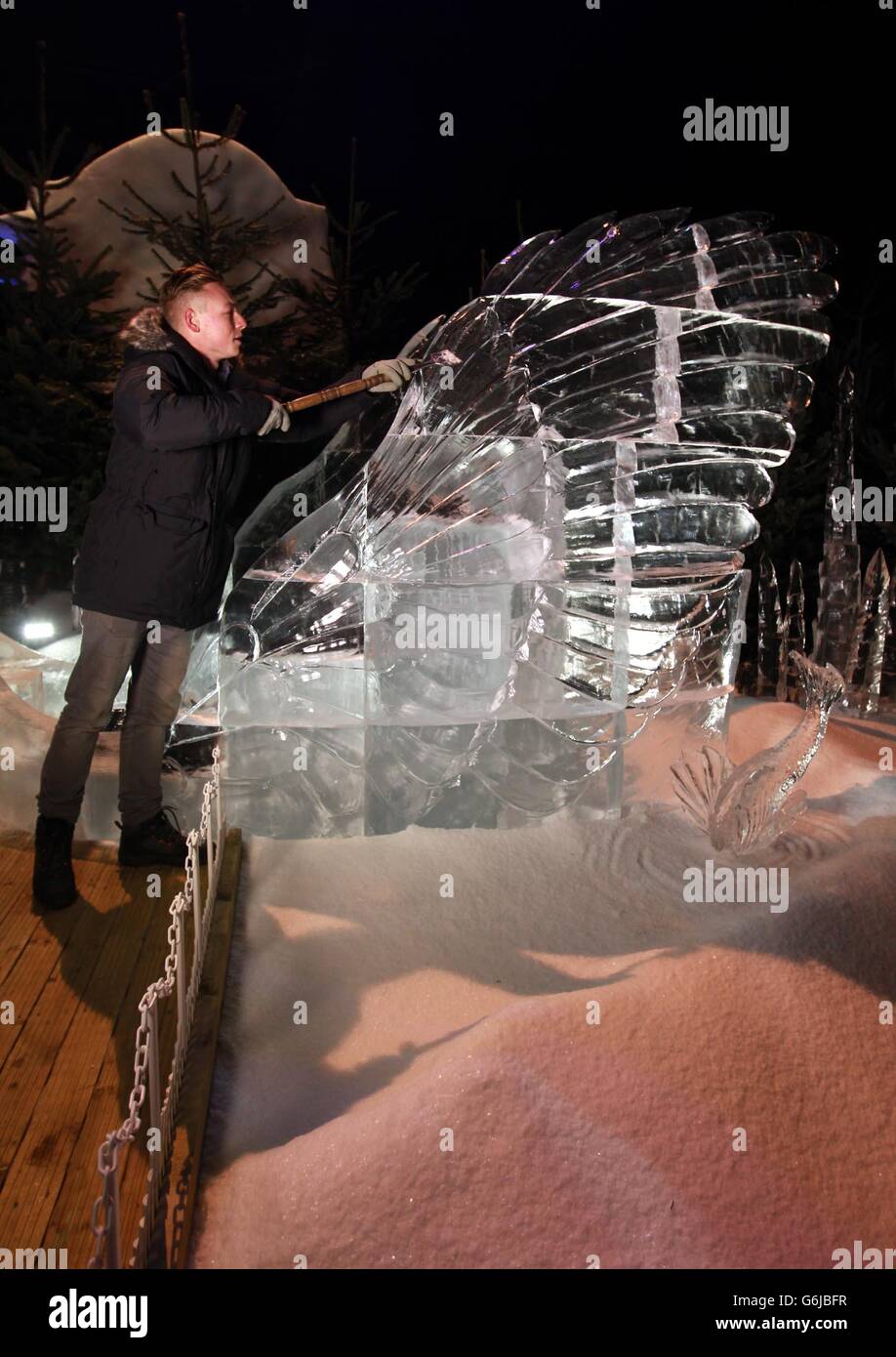 Sculptor Jack Hackney puts the finishing touches to ice sculptures in ...