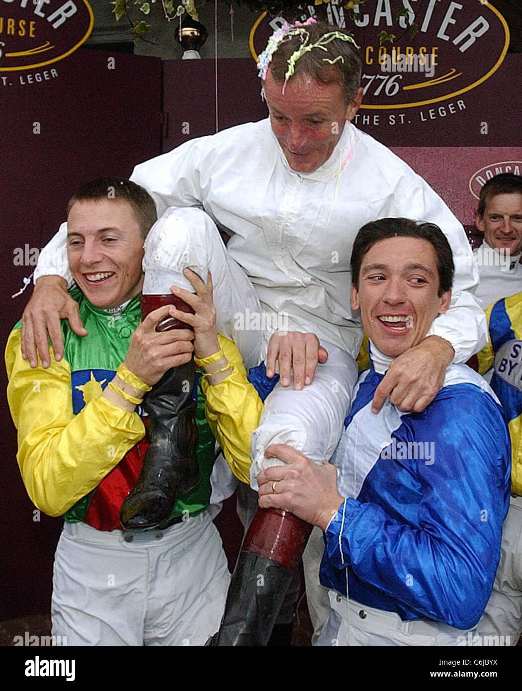 Jockey Pat Eddery is carried from the Doncaster racecourse weighing ...