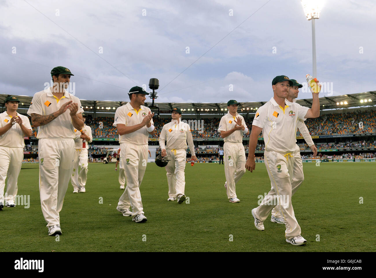 Australian players congratulate David Warner (right) as the players ...