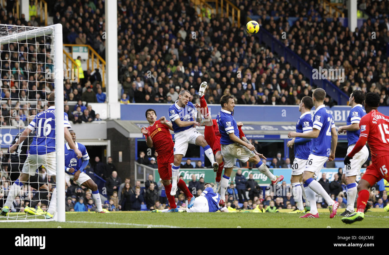 Everton's Leon Osman and Phil Jagielka head the ball away from danger ...