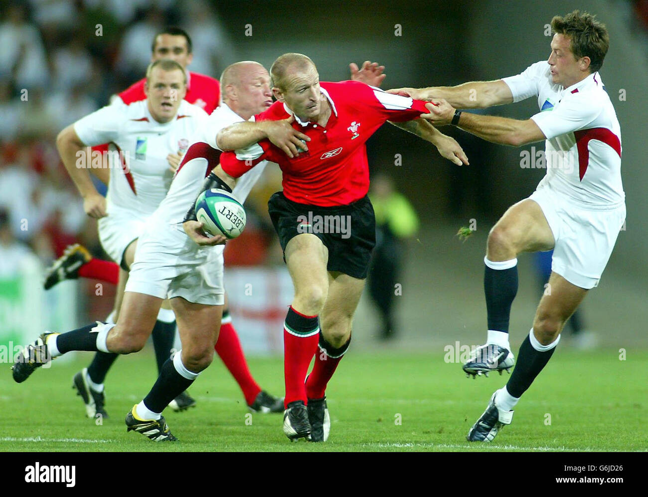England's Neil Back and Dan Luger tackle Wales' Gareth Thomas during ...