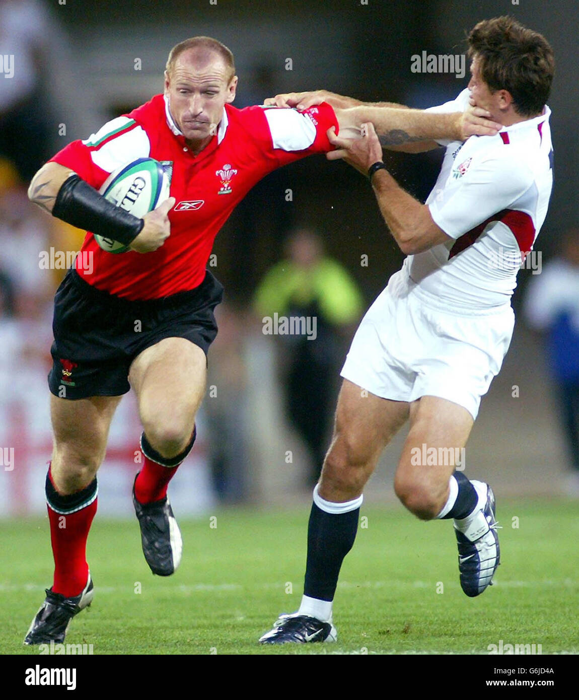 Wales's Gareth Thomas hands off England's Dan Luger during their Rugby ...