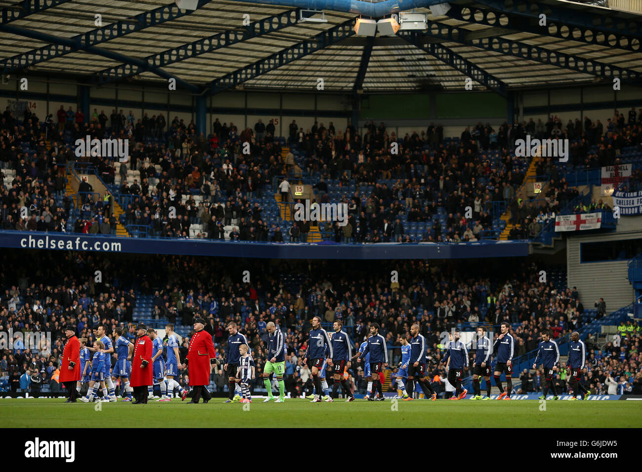 The teams are led out by Chelsea Pensioners to observe a minutes ...