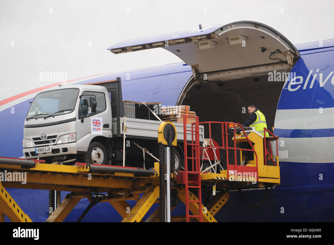 Ground staff load equipment onto a Boeing 747 at East Midlands Airport ...