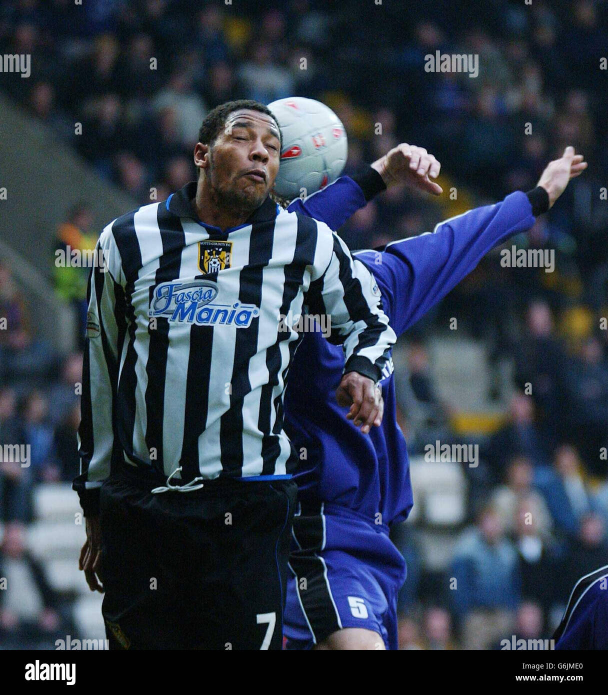 Notts County striker Clive Platt gets the ball and an arm in the neck ...