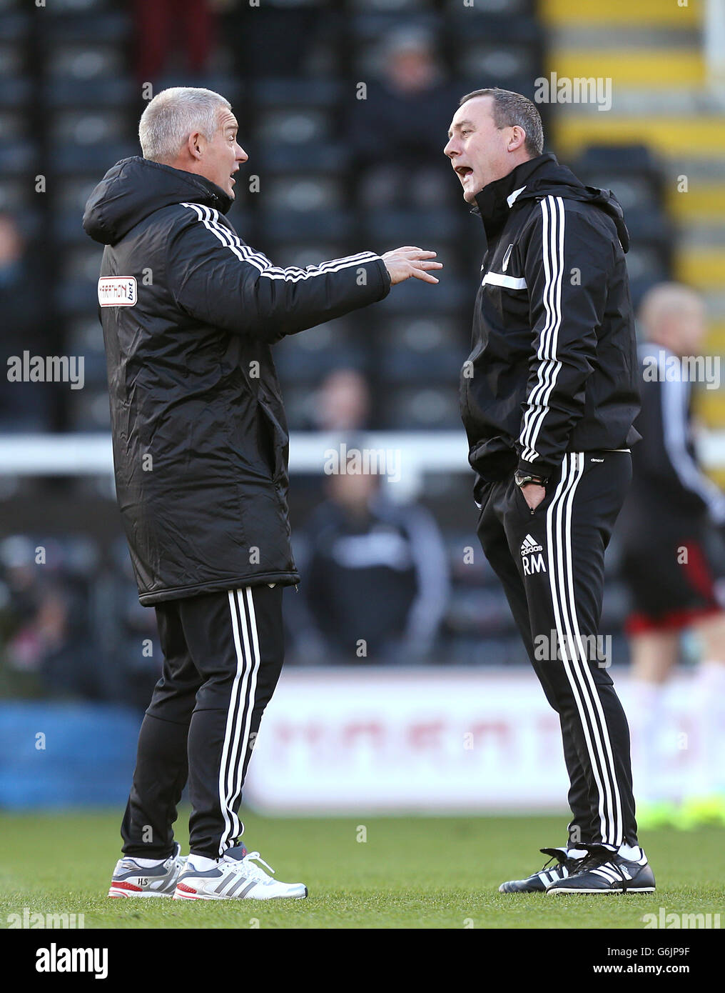 Fulham assistant manager Rene Meulensteen (right) speaks with ...