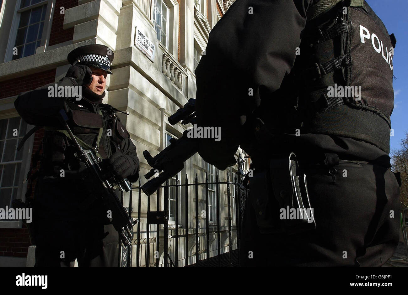 Armed Police stand on guard near the American Embassy in London's ...