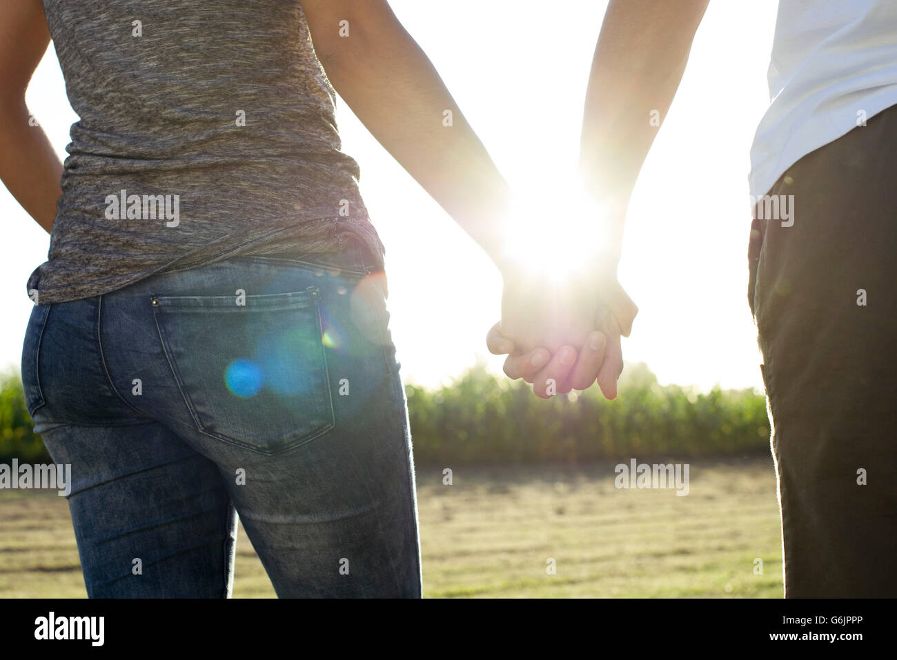 Couple holding hands taking walk together Stock Photo - Alamy