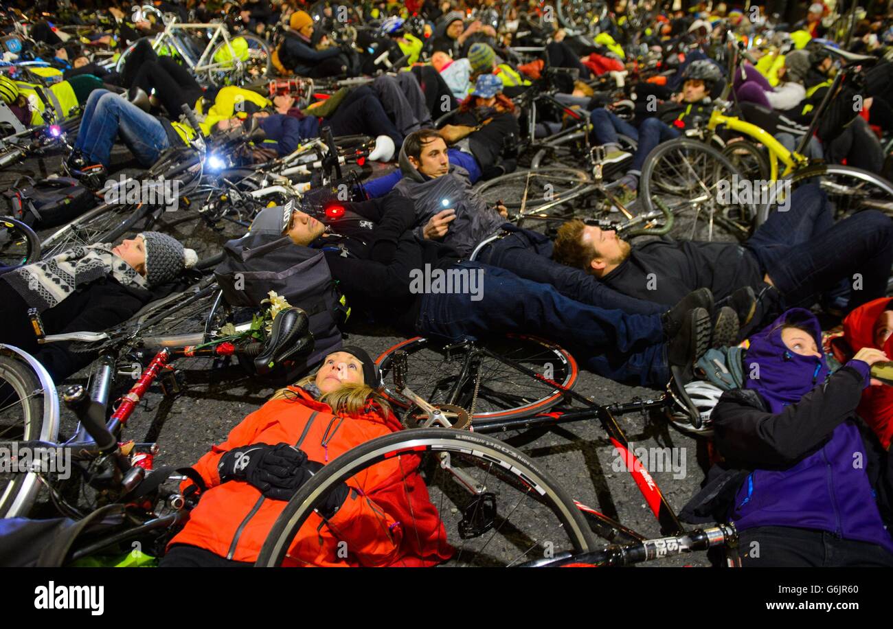 Cyclists take part in a 'die-in' protest outside the headquarters of ...