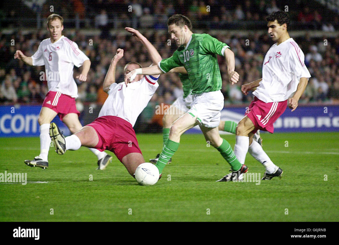 Ireland's Robbie Keane (right), is tackled by Canadas' Jason de Vos ...