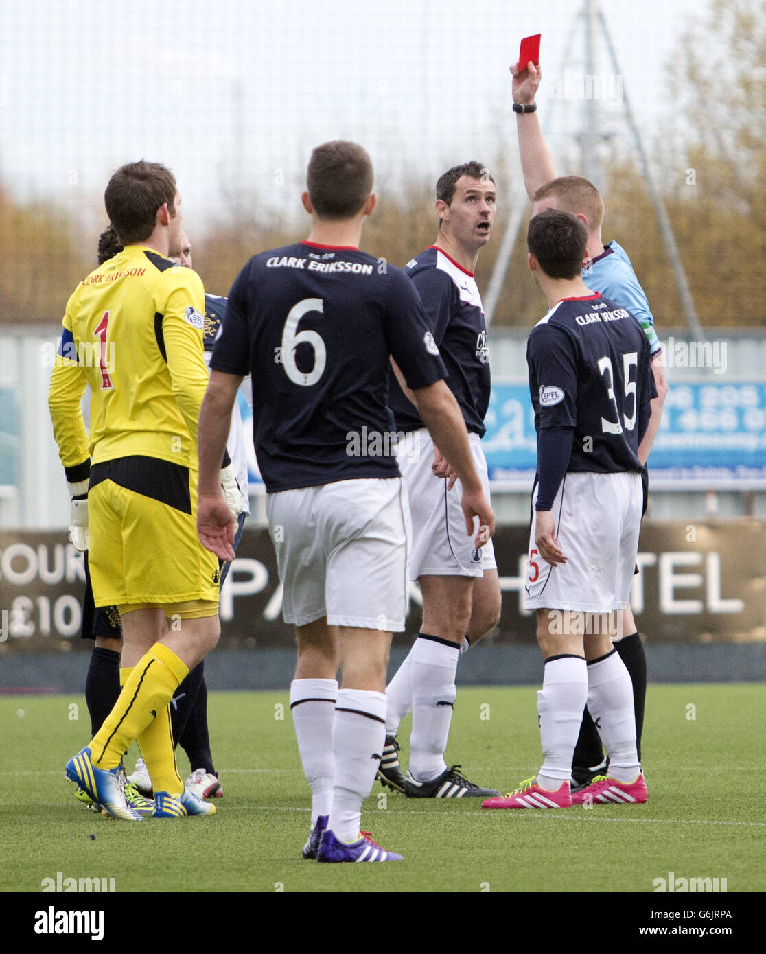 Falkirk's David McCracken is shown a red card by referee Brian Colvin ...