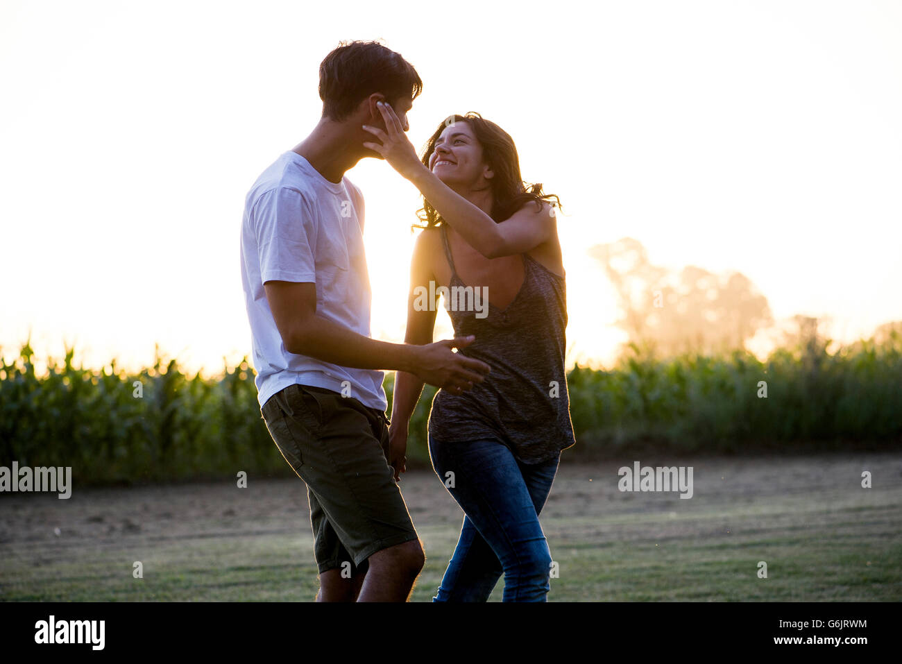Woman caressing boyfriend's cheek Stock Photo - Alamy