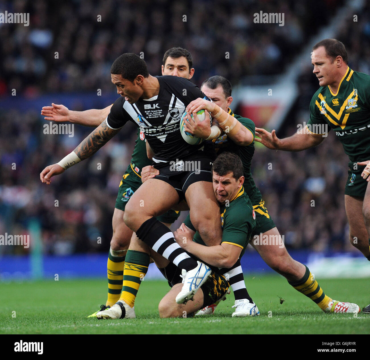 New Zealand's Manu Vatuvei is tackled by a strong Australia defence ...