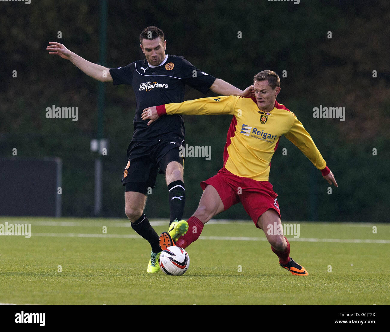 Motherwell's Stephen McManus (left) and Albion Rovers' Chris Dallas ...