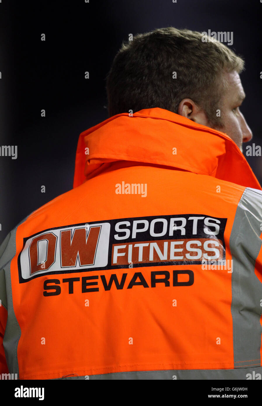 A Steward with DW Sports Fitness branding on his coat Stock Photo - Alamy