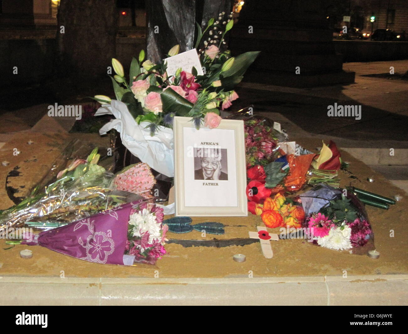 Floral tributes are placed by the statue of Nelson Mandela in ...