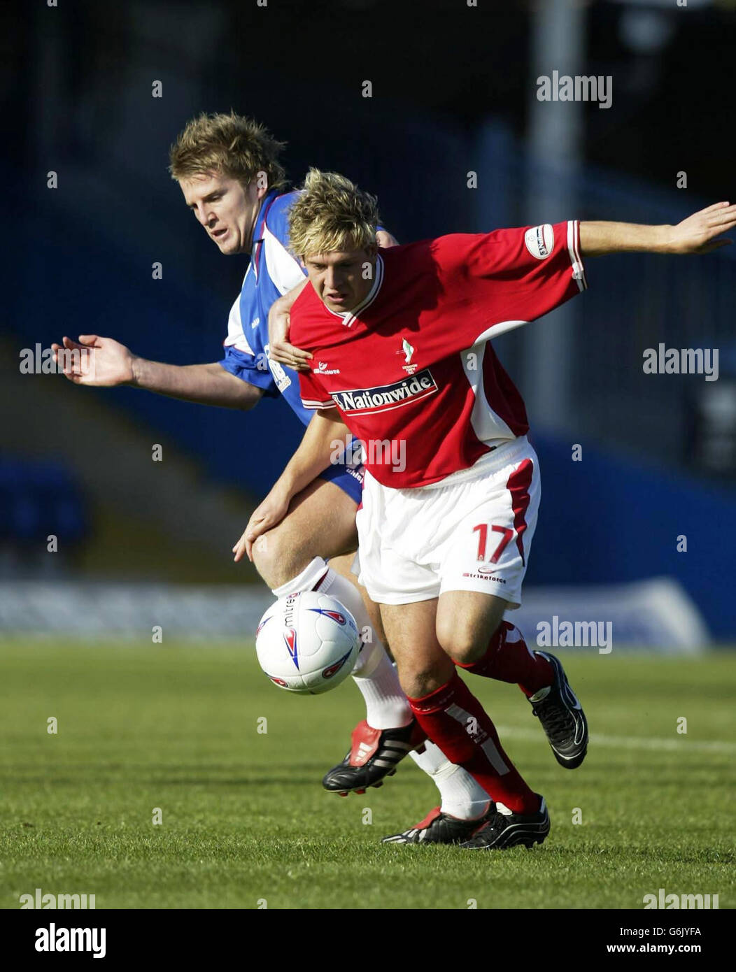 Chesterfield's Jamie Cade (left) battles for the ball with Brian Howard ...
