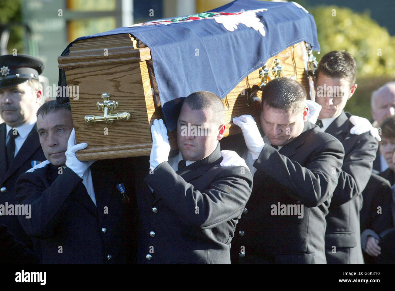 Firefighters carry the coffin of part-time fireman Joe McCloskey, from ...