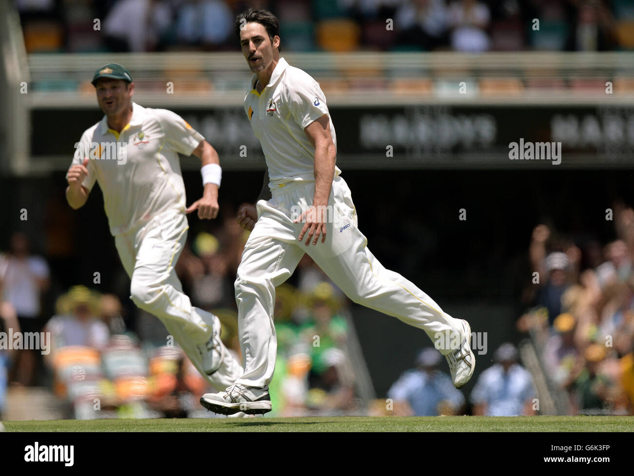 Australia's Mitchell Johnson (centre) celebrates taking the wicket of ...