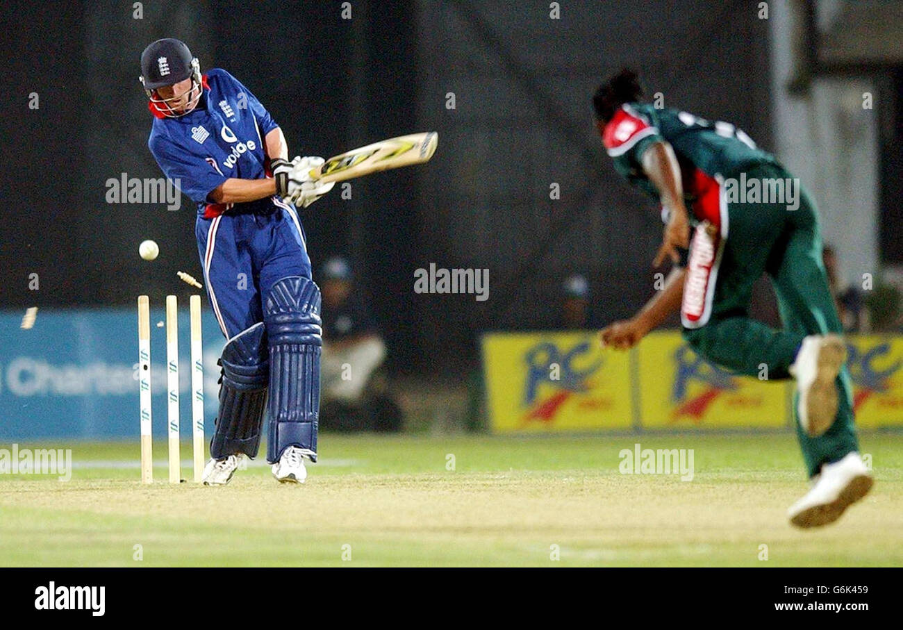England's Paul Collingwood is clean bowled by Tapash Baisya (right ...
