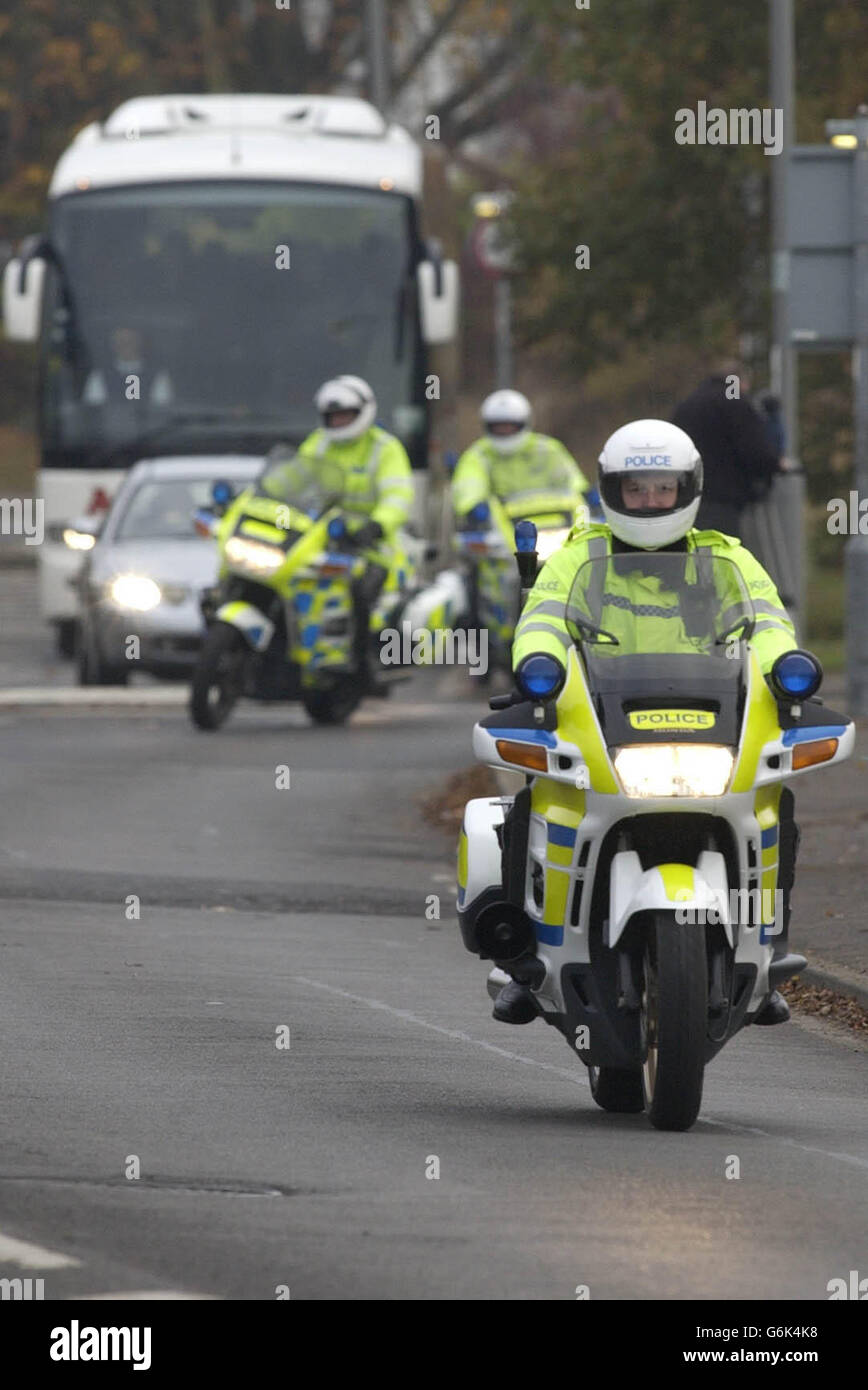 Police outriders pave the way for the coach carrying the jury in the ...