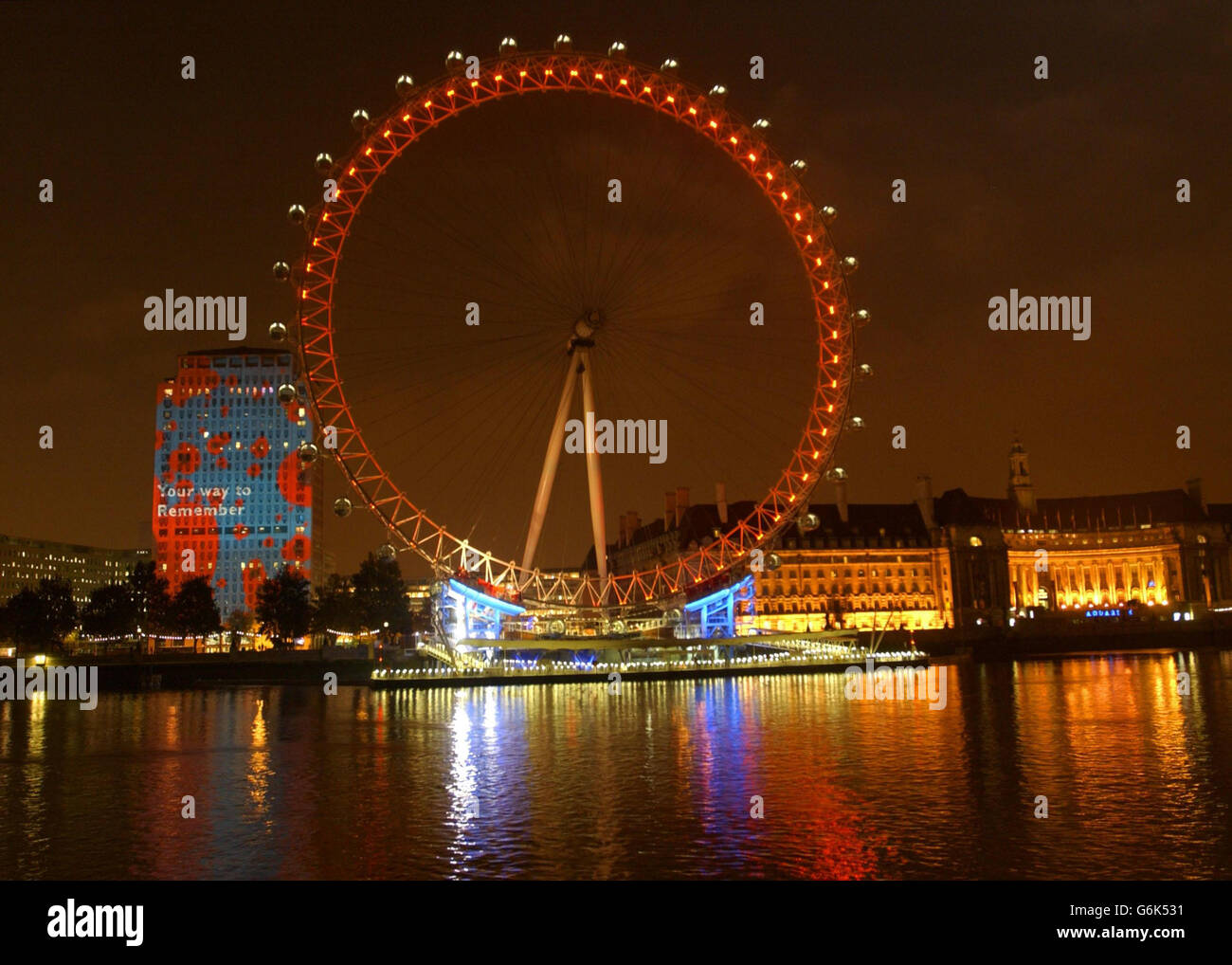 London eye illuminated in red illuminations switched on evening hi-res ...