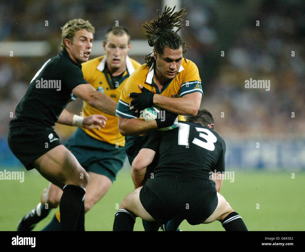 Australia's George Smith surges into the tackle of New Zealand's Leon ...