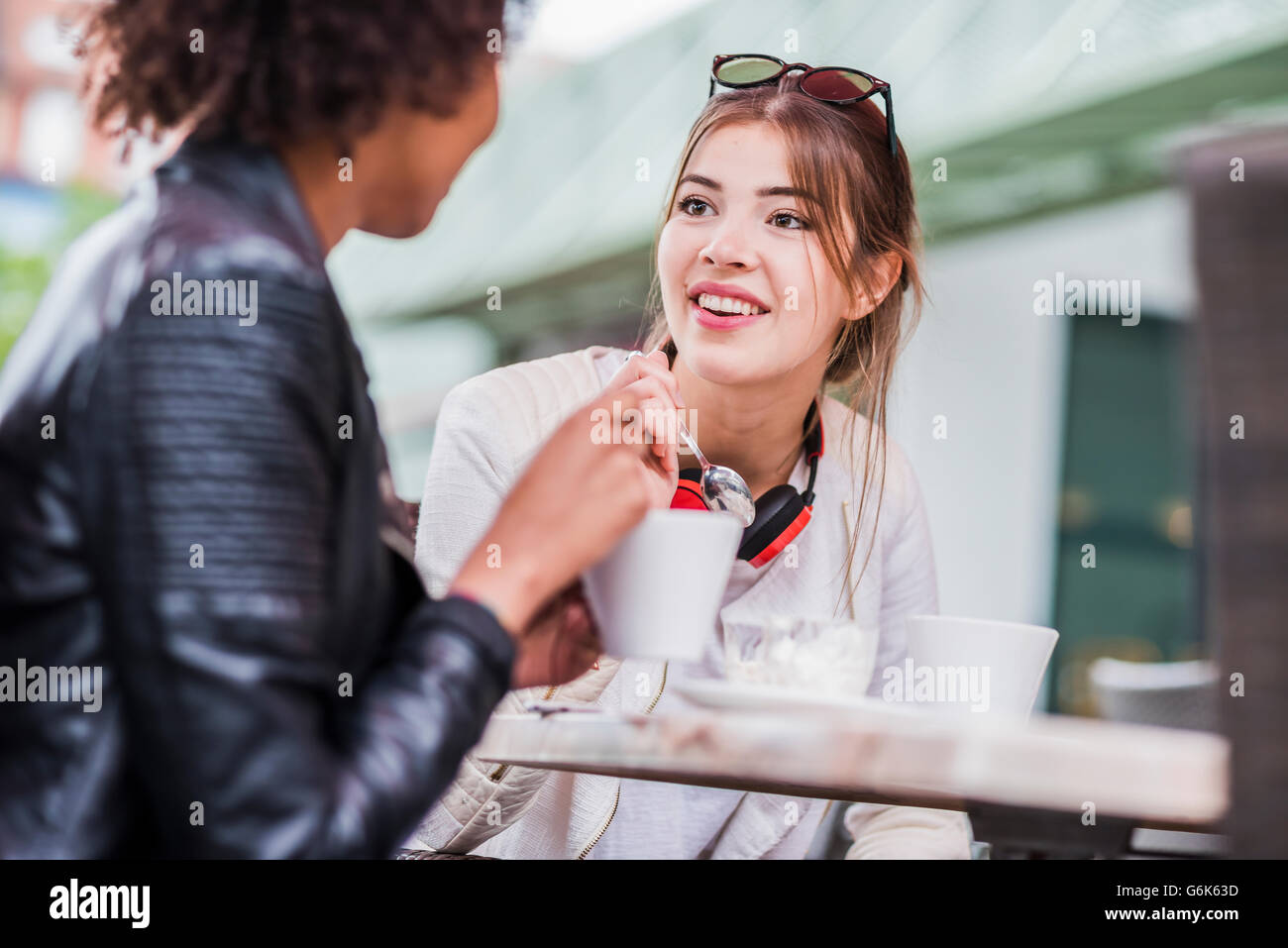 Two best friends talking in a cafe Stock Photo - Alamy
