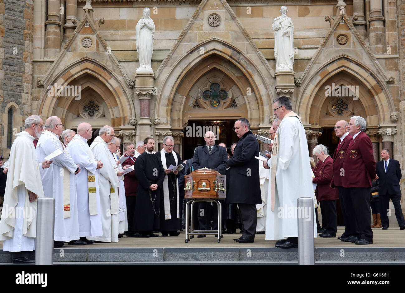 The coffin of Father Alex Reid after the funeral service at Clonard ...