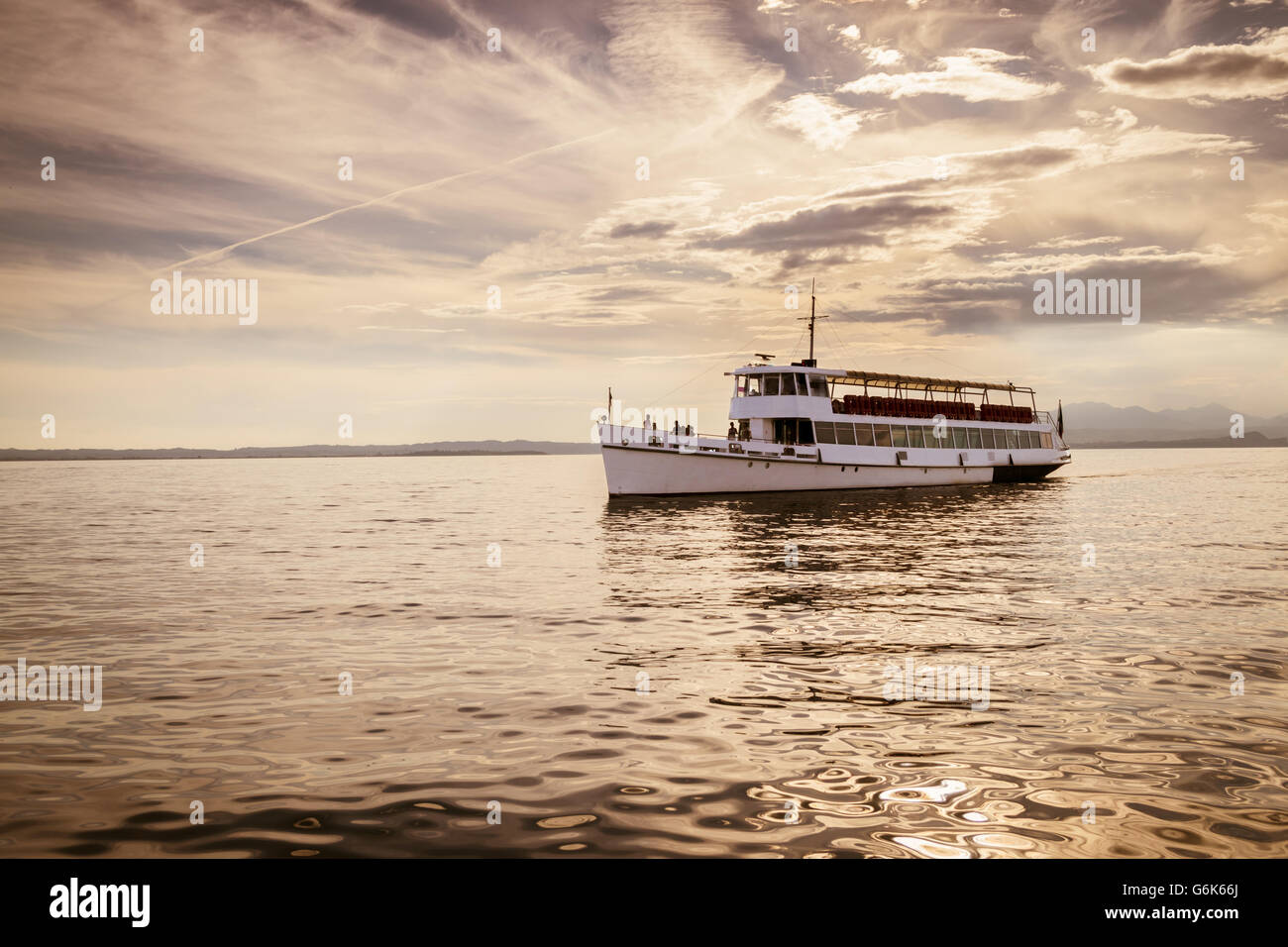 White ferry on Lake Garda at sunset Stock Photo - Alamy