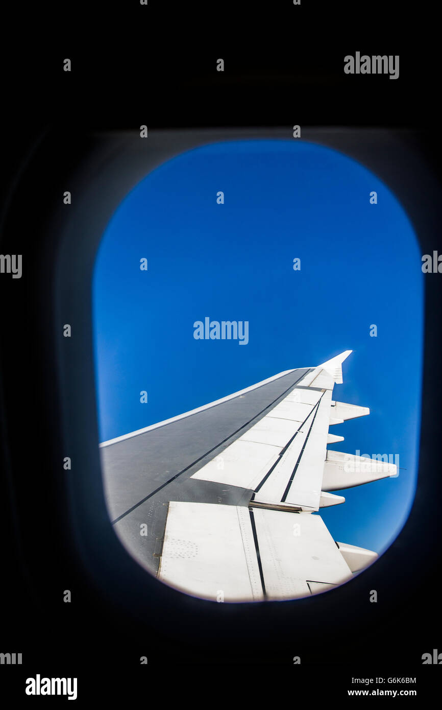 Airplane wing from a window of an airplane Stock Photo - Alamy