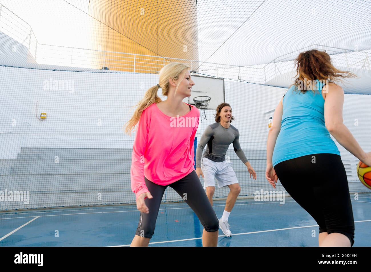 Three people playing basketball on a deck of a cruise ship Stock Photo ...