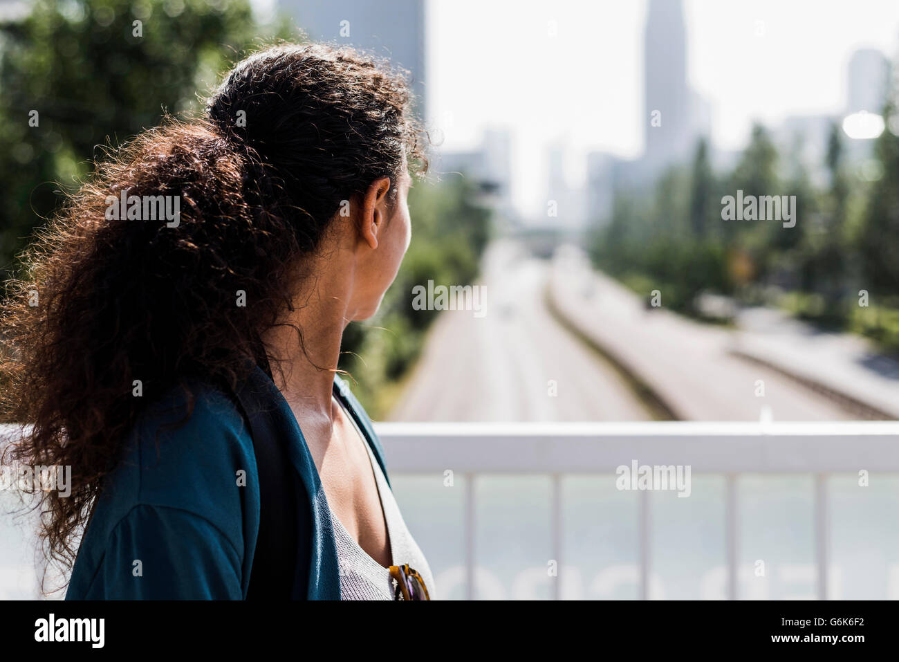 Young woman on bridge looking on street Stock Photo - Alamy