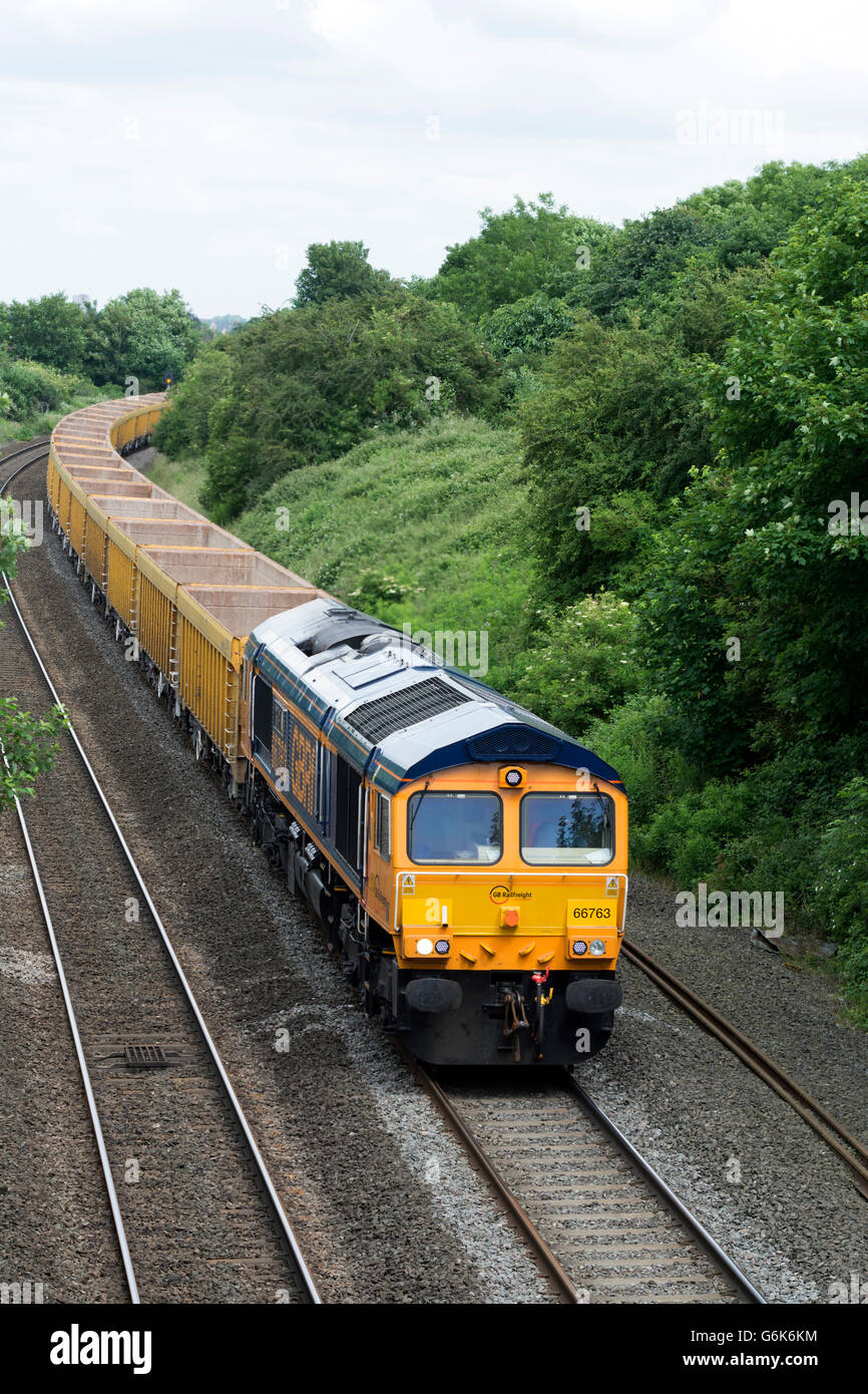 GBRf Class 66 diesel locomotive pulling an empty stone ballast train ...