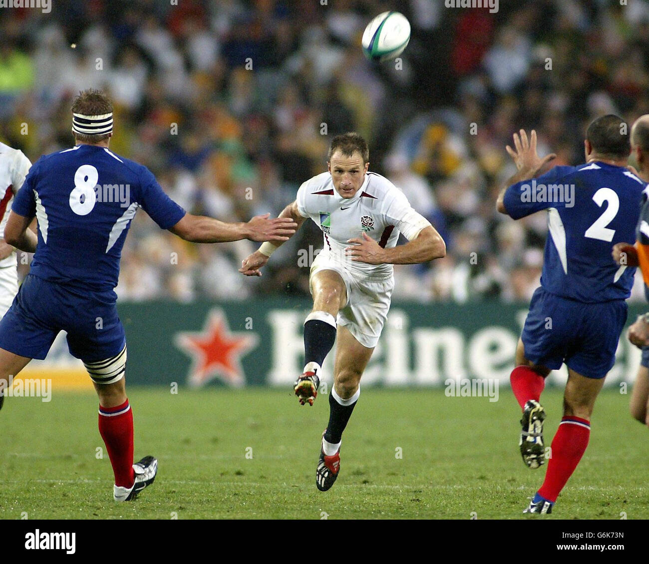 England's Mike Catt kick between France's Imanol Harinordoquy(left) and ...