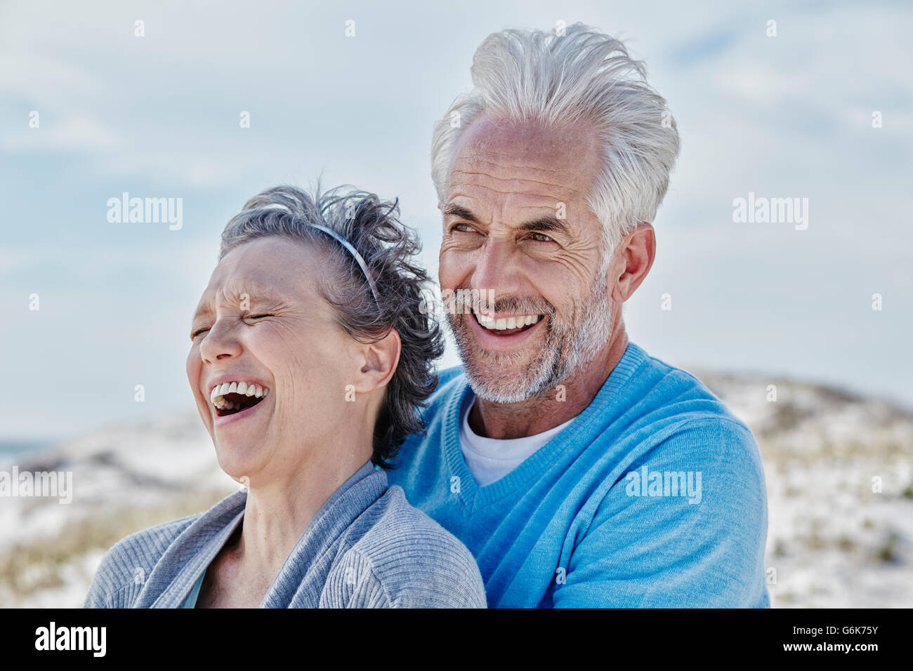 Laughing couple on the beach Stock Photo - Alamy