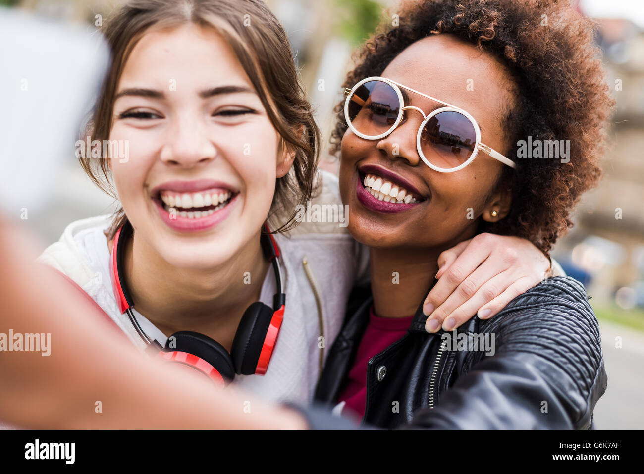 Portrait of two happy best friends taking selfie with smartphone Stock ...