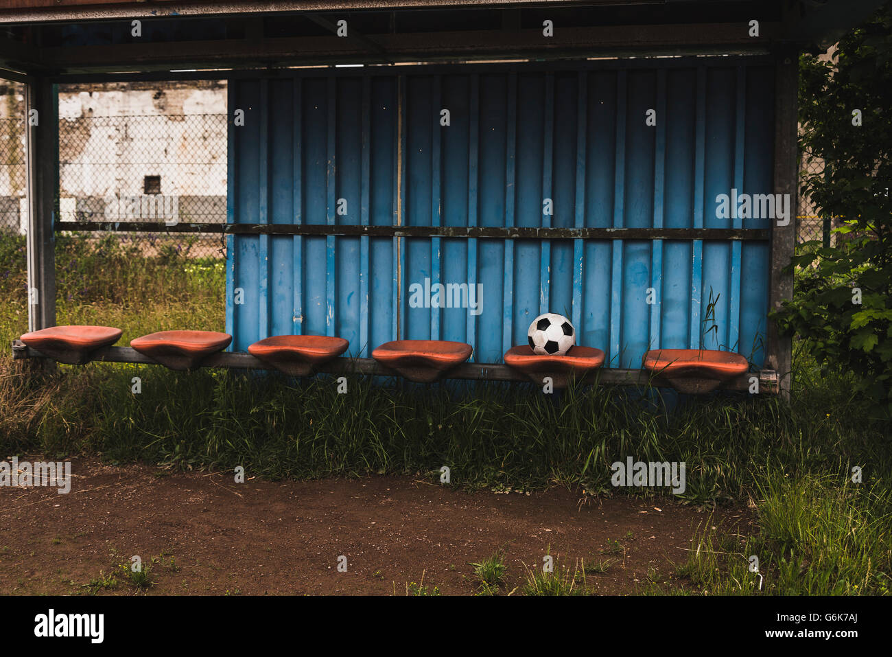 Football on empty coaching bench Stock Photo - Alamy