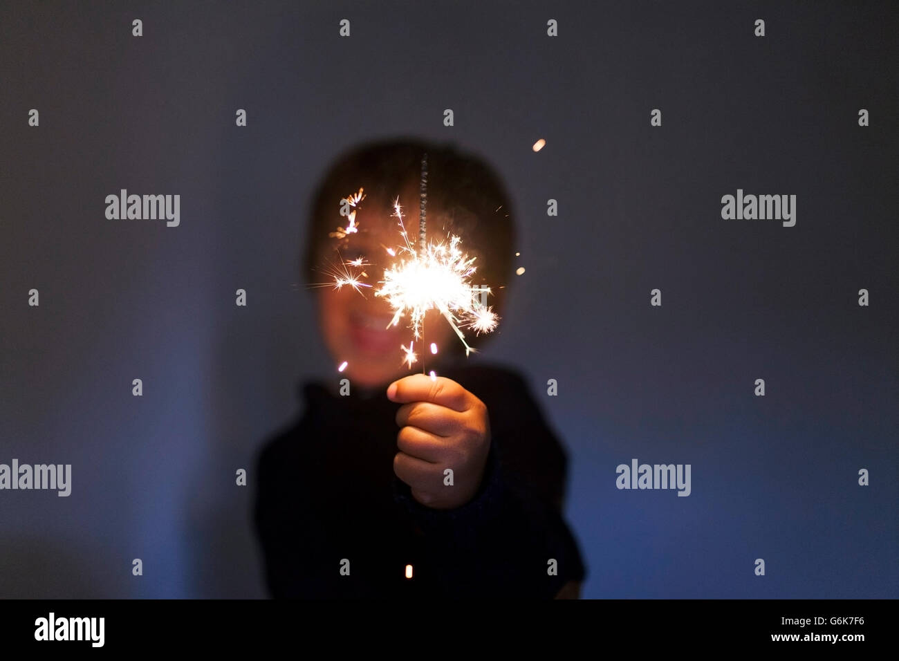 Ltle boy holding a sparkler Stock Photo - Alamy
