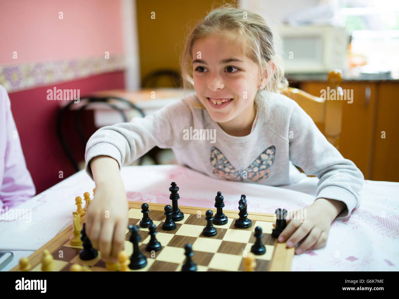 Little girl playing chess Stock Photo - Alamy