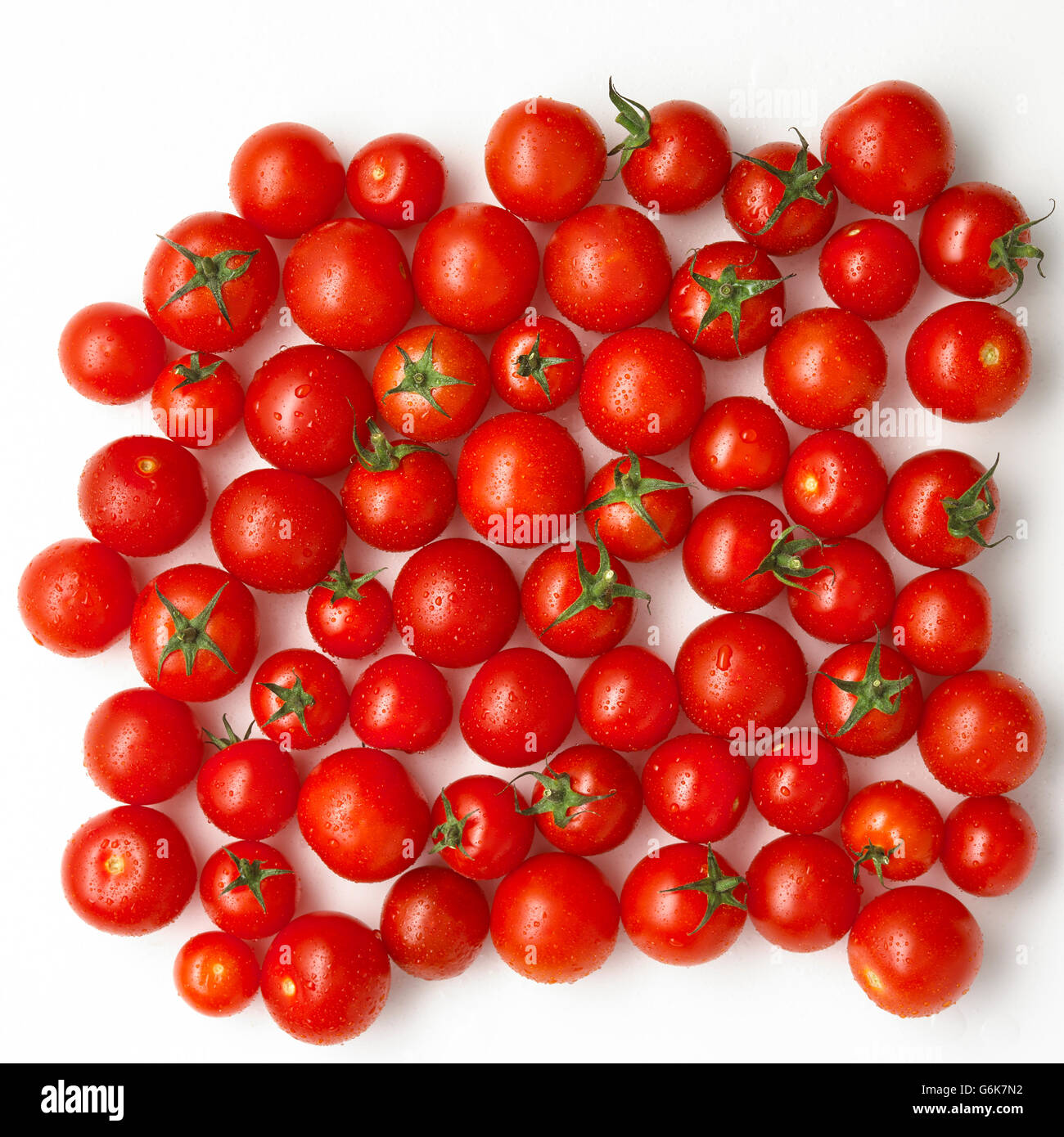 Wet mini tomatoes on white ground Stock Photo - Alamy