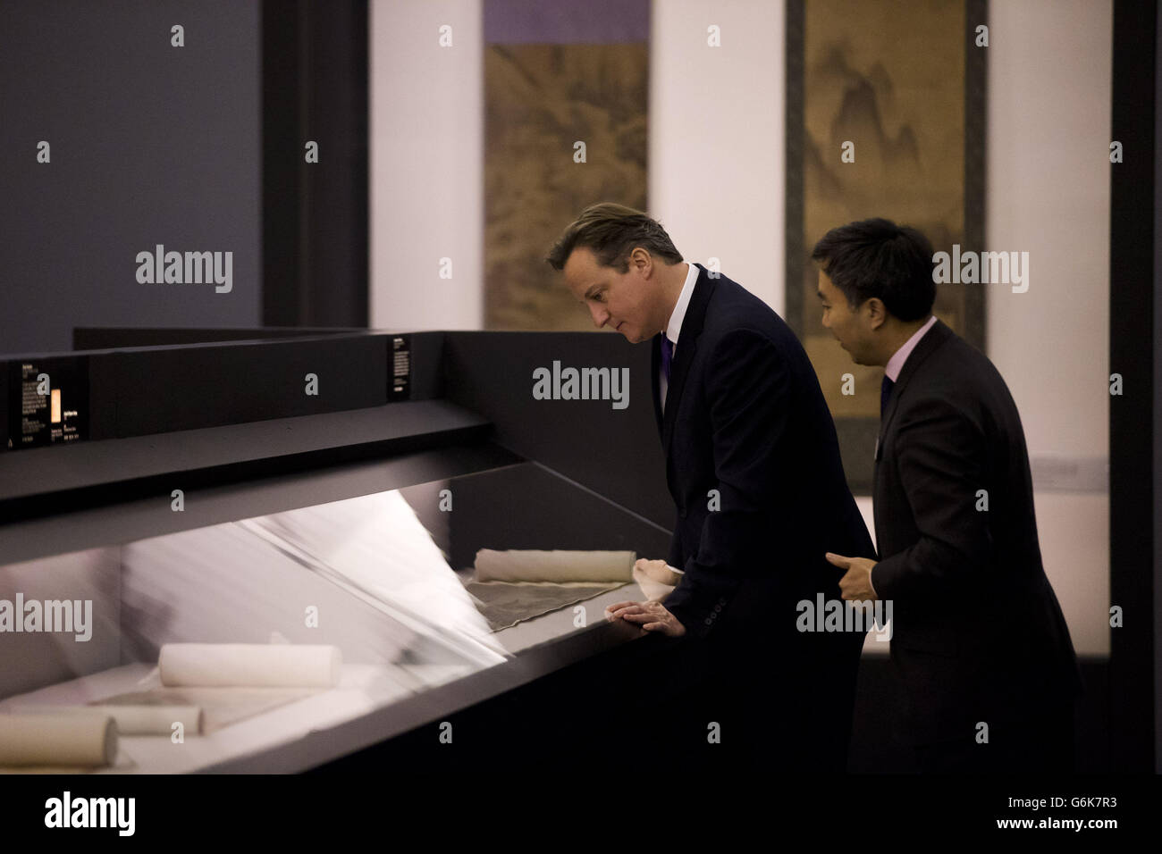 Prime Minister David Cameron, left, is shown works by curator Zhang ...