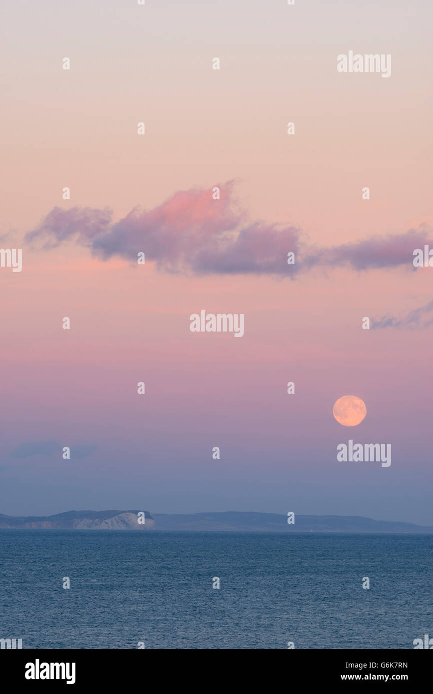 UK, Dorset, full moon at sunset Stock Photo - Alamy