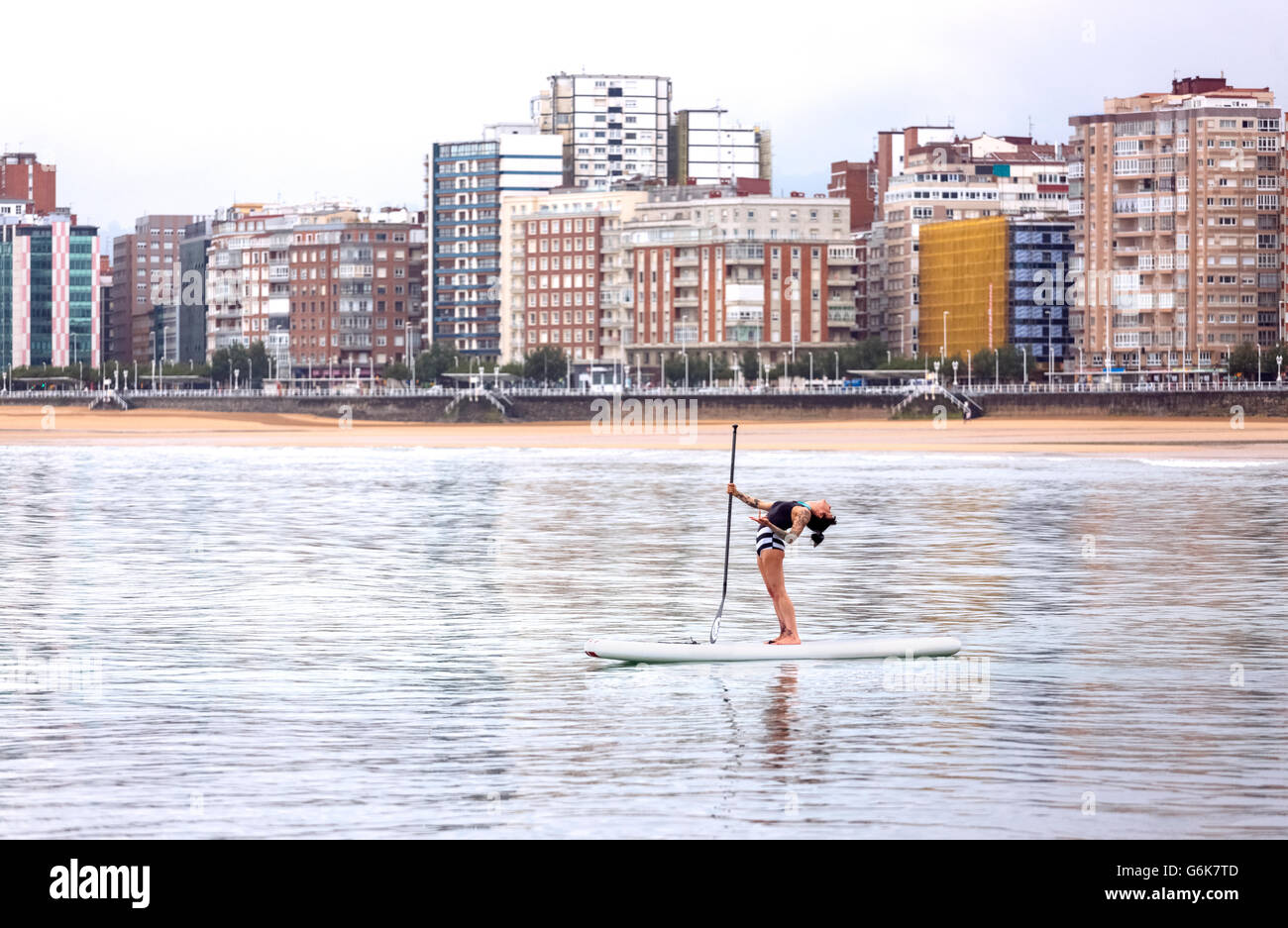 Spain, Gijon, woman practicing paddle board yoga Stock Photo - Alamy