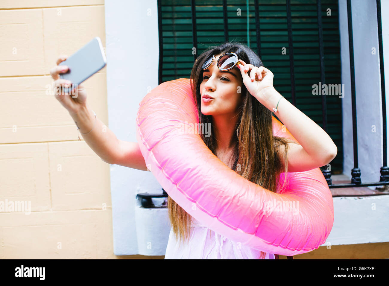 Young woman with bathing ring around the neck taking a selfie Stock ...