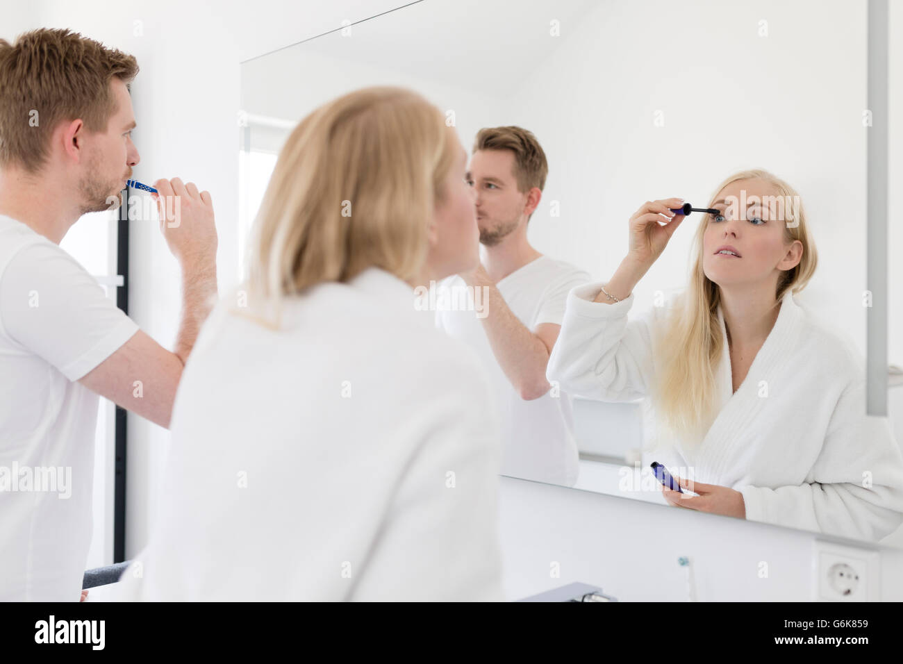 Couple grooming in bathroom Stock Photo - Alamy