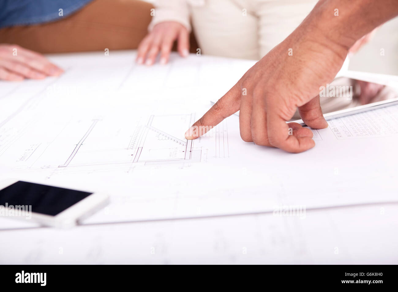 Hand pointing on construction plan Stock Photo - Alamy