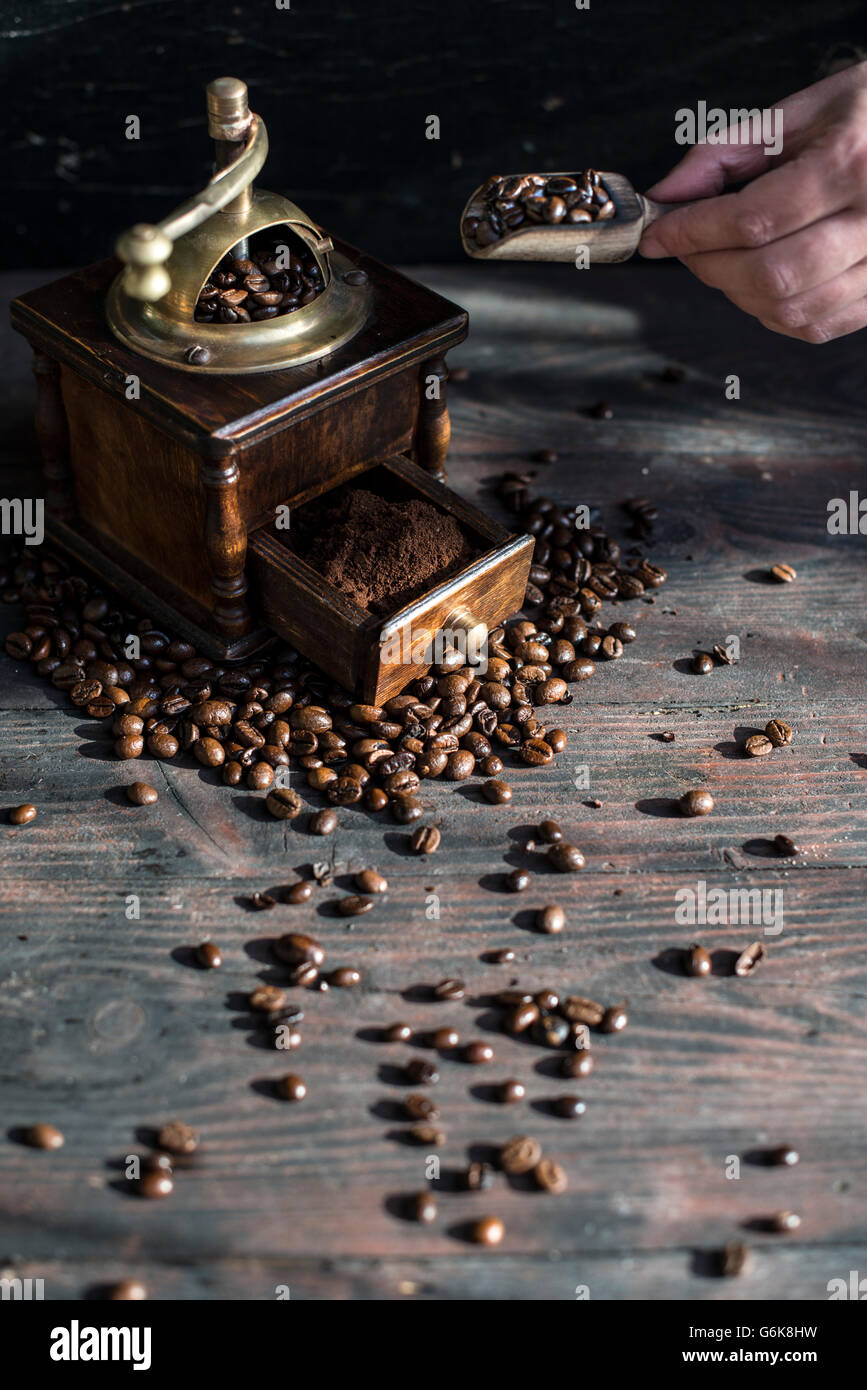 Grinding coffee with vintage coffee mill Stock Photo - Alamy