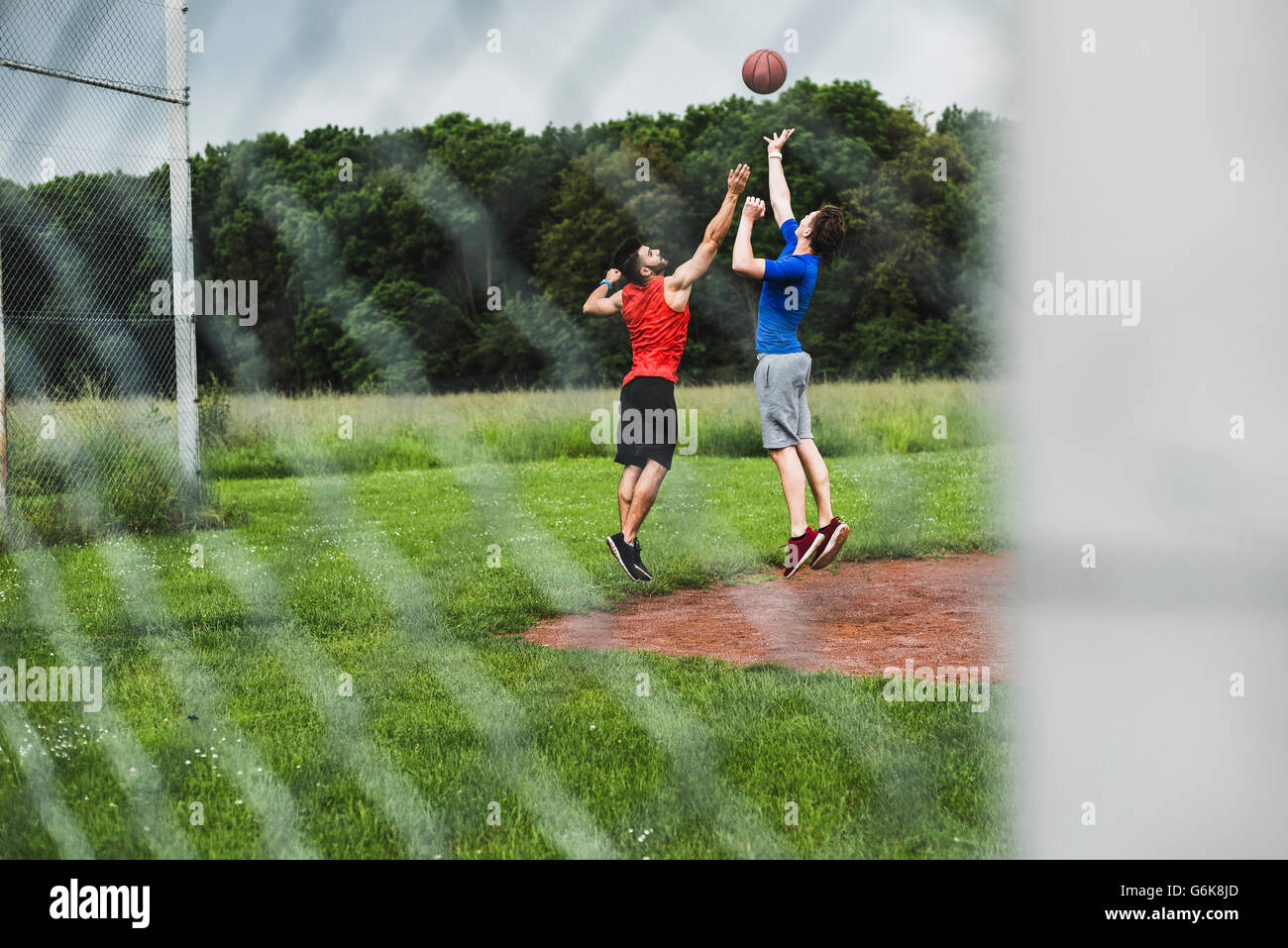 Two men playing basketball outdoors Stock Photo - Alamy